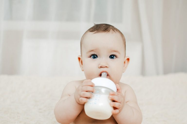 Baby Spitting Up: Causes & Solutions | New Parenting Guide